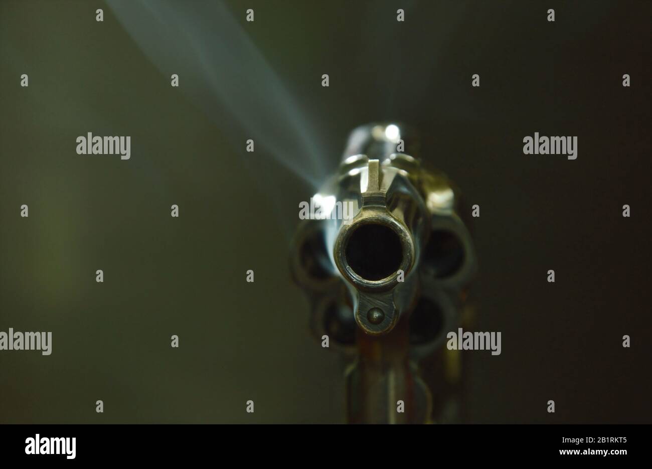 revolver gun muzzle with smoke floating in the air after shoot on black ...
