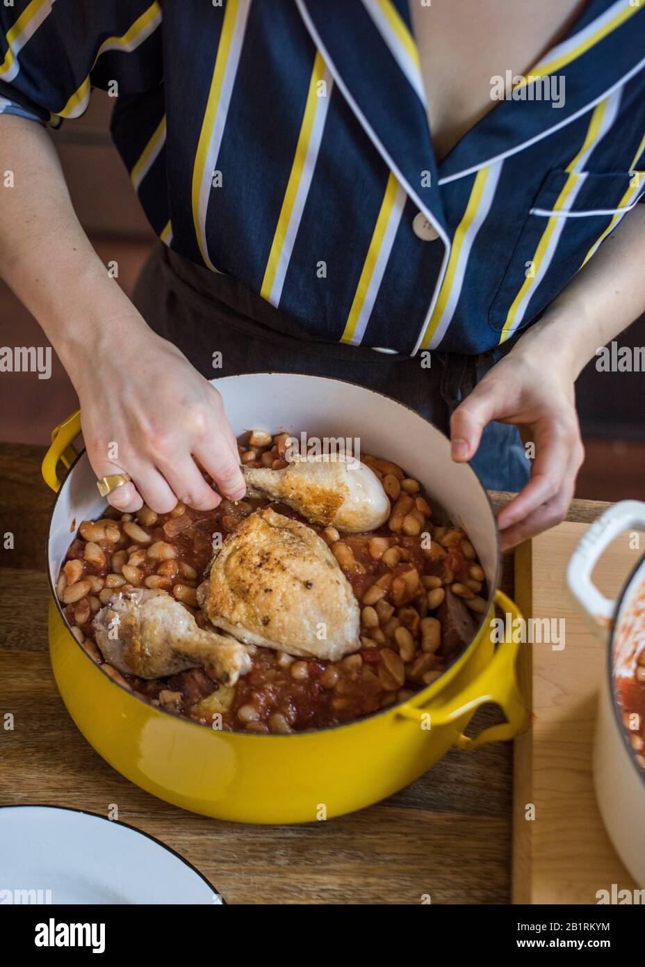 Woman layering Cassoulet ingredients in pot Stock Photo - Alamy