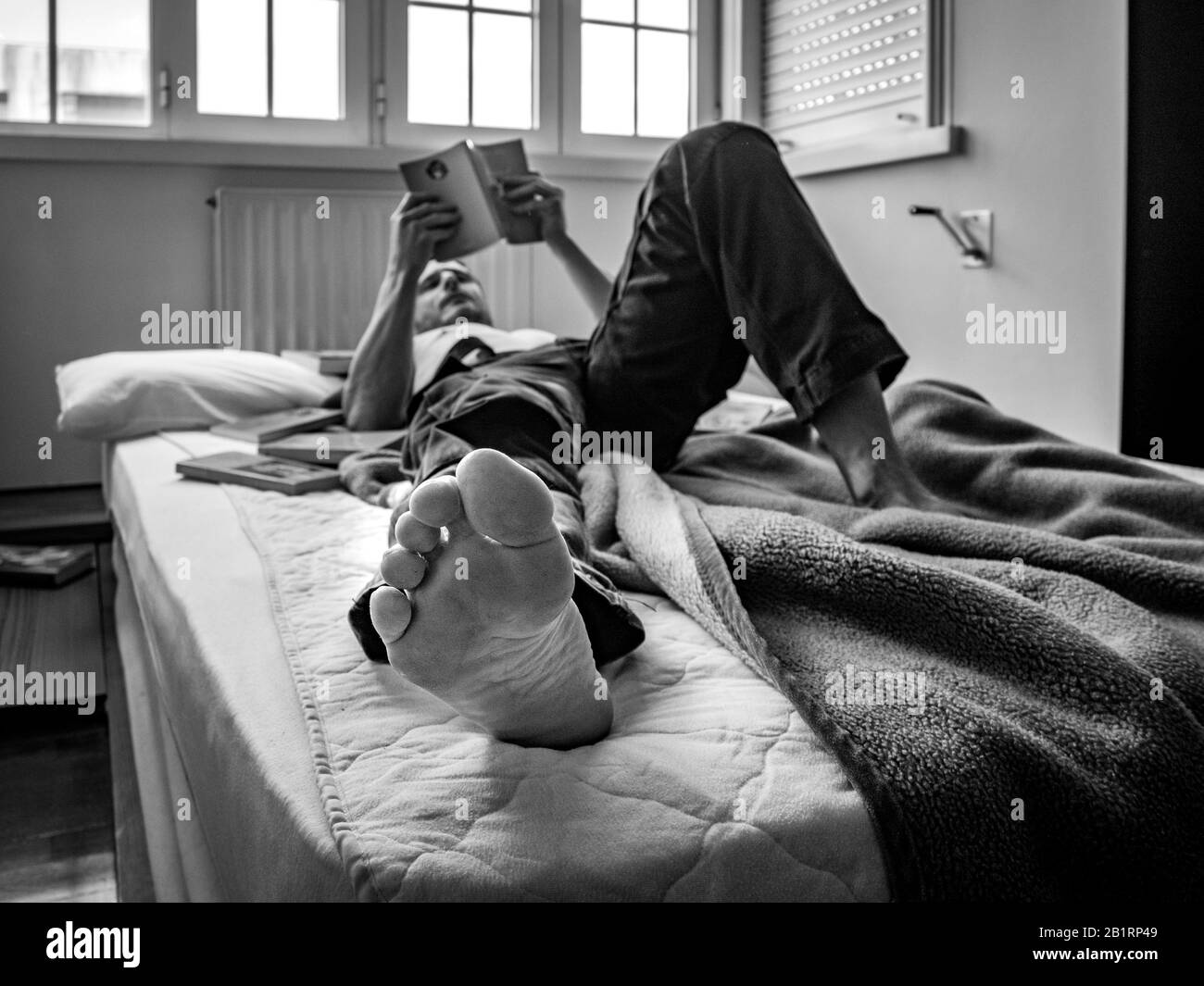Man reading bed Black and White Stock Photos & Images - Alamy