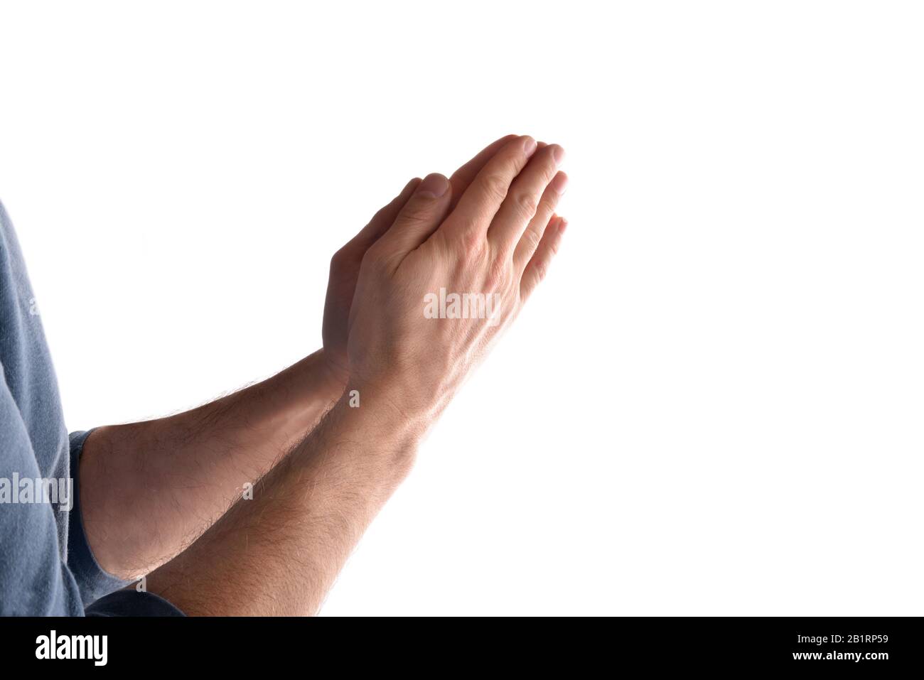 Man with hands together in prayer position isolated white. Horizontal ...