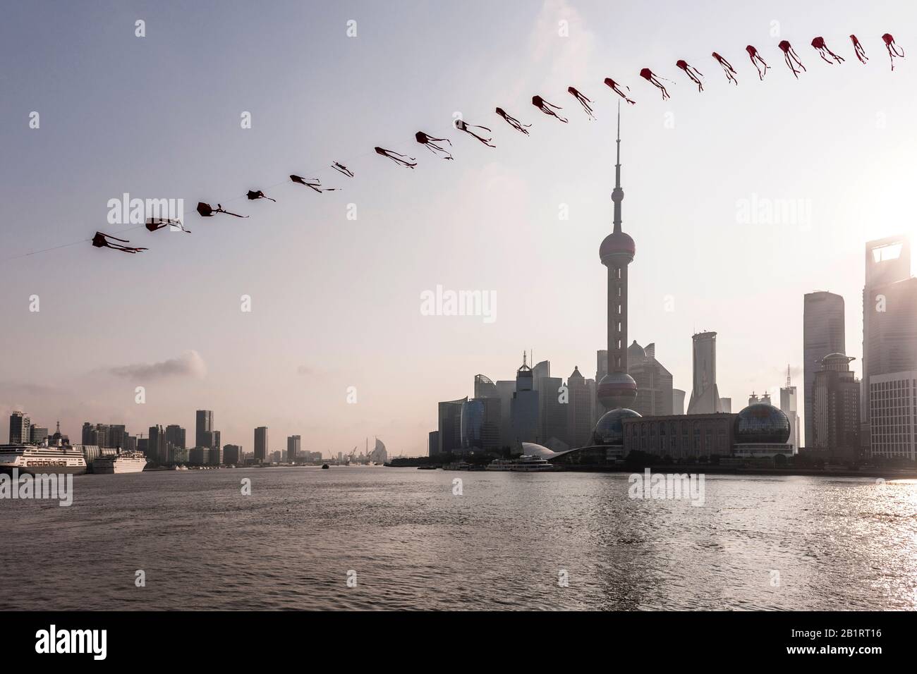Hang gliding on the Bund, waterfront, sunrise, Pudong skyline, Shanghai ...