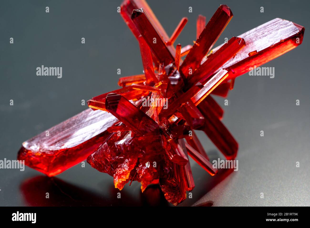 Red crystalline minerals on a black background Stock Photo - Alamy