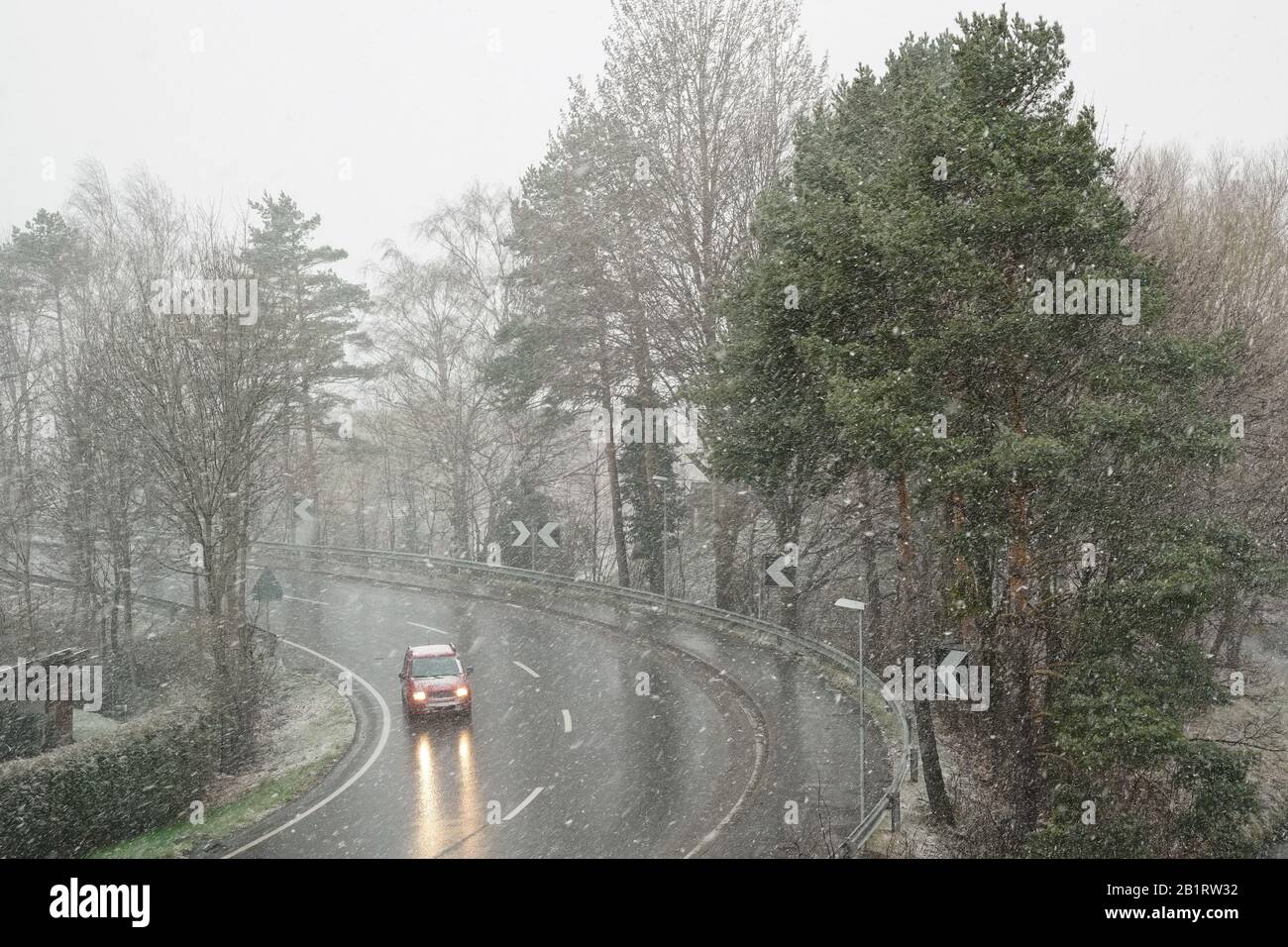 Car driving slowly street hi-res stock photography and images - Alamy