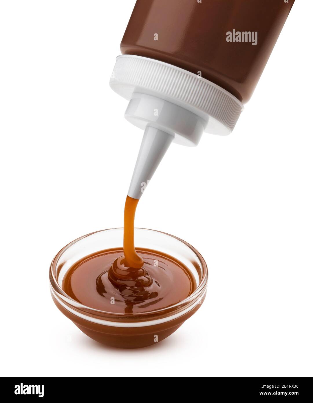 Pouring caramel sauce with bottle isolated on white background Stock ...