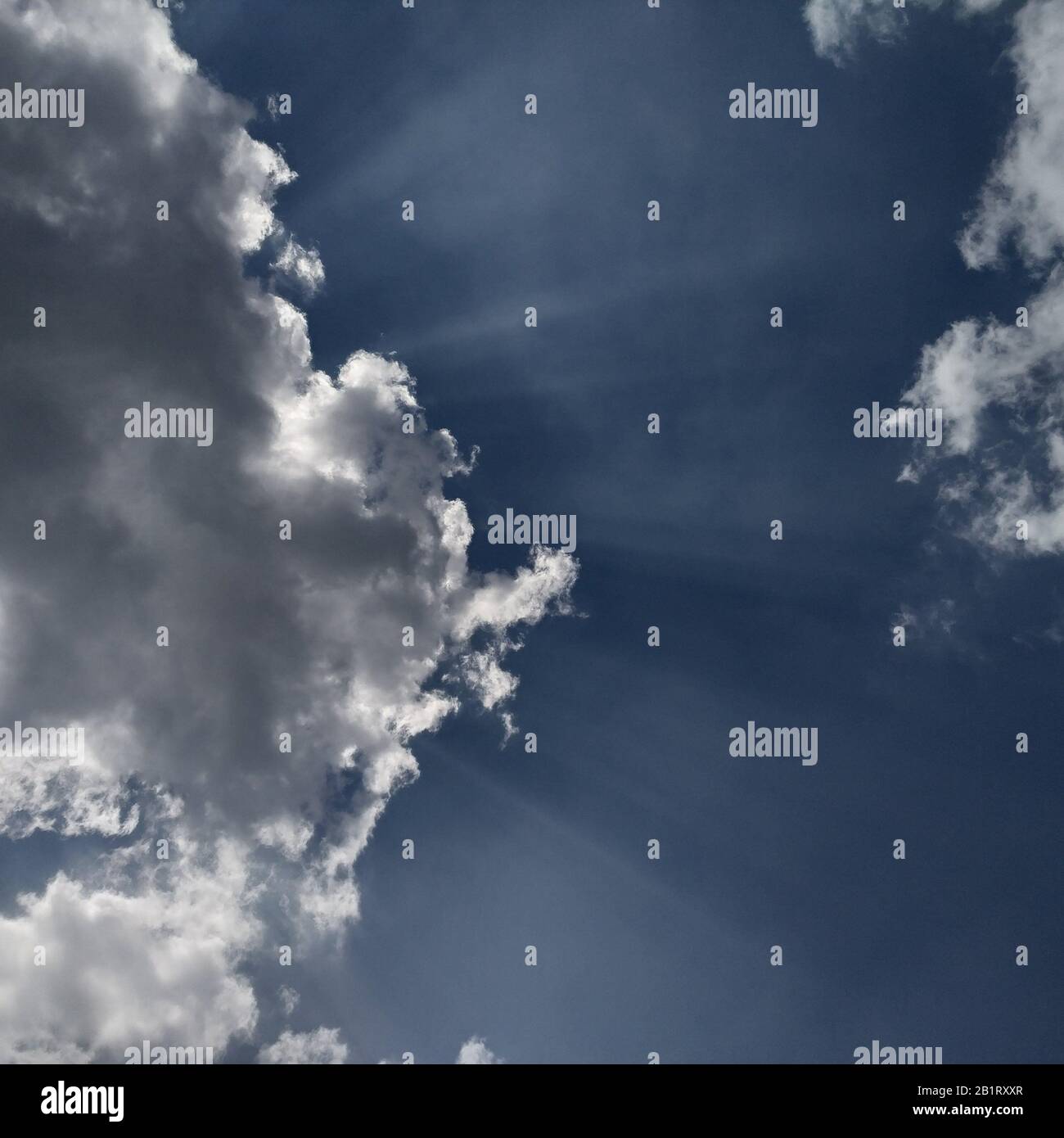 Sun rays shining through clouds hi-res stock photography and images - Alamy