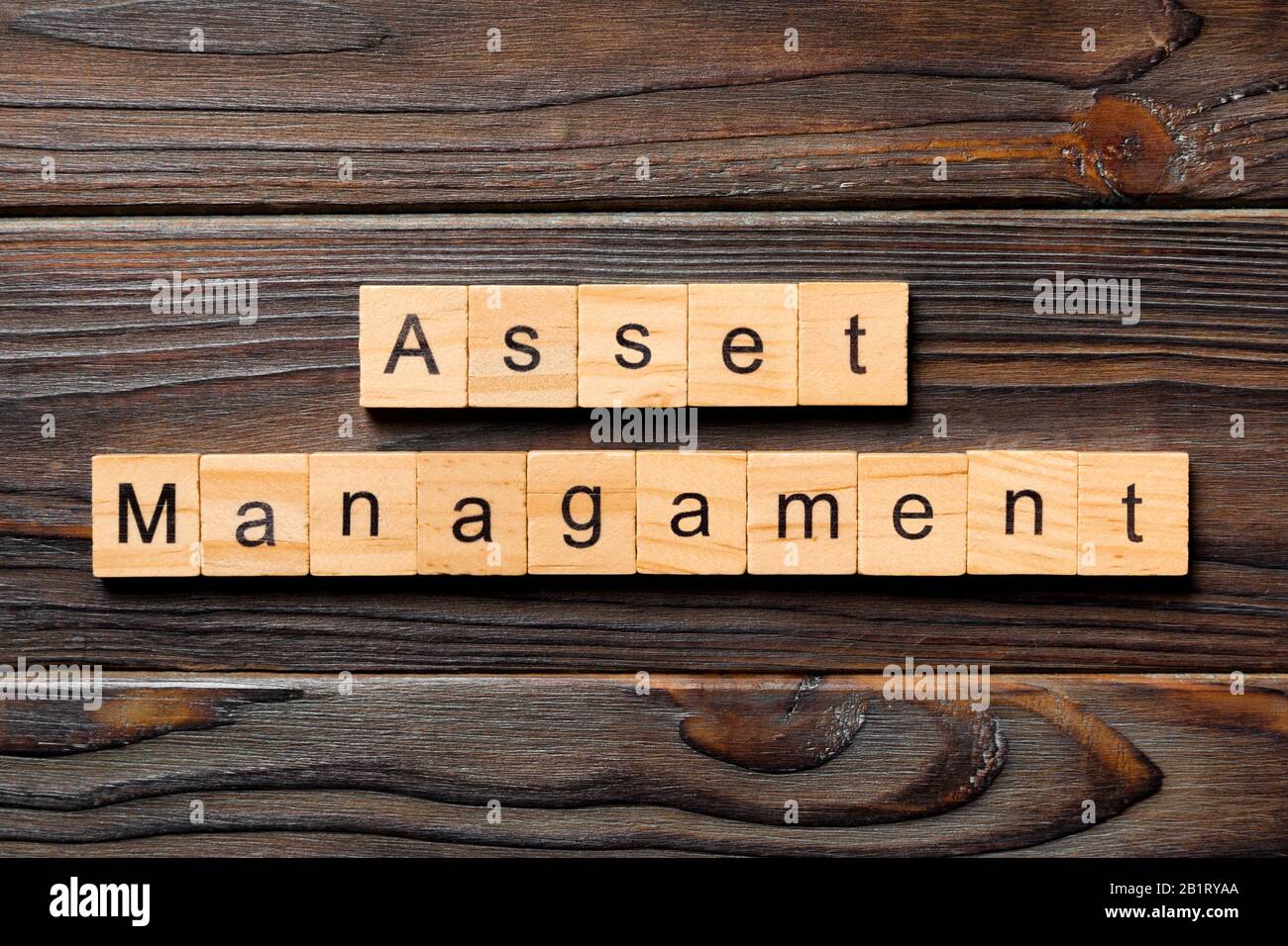 Asset management word written on wood block. Asset management text on ...