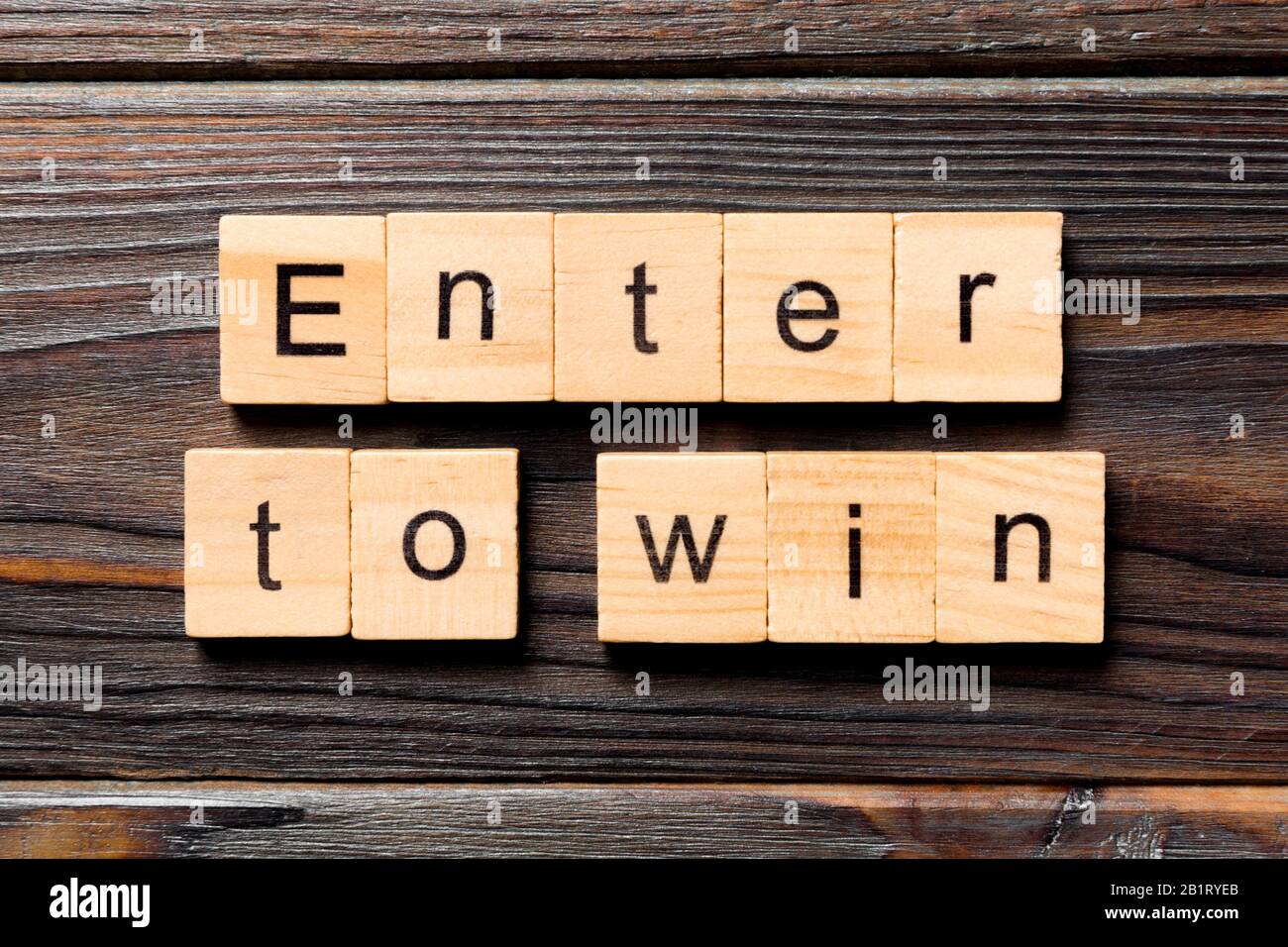Enter To Win word written on wood block. Enter To Win text on wooden ...