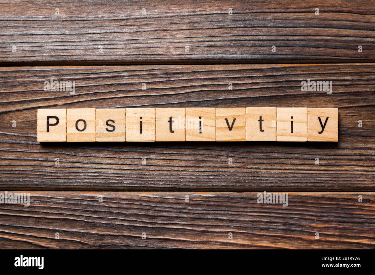positivity word written on wood block. positivity text on wooden table ...