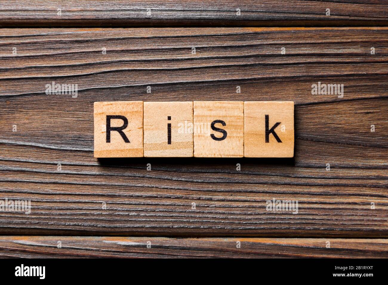 Risk word written on wood block. Risk text on wooden table for your ...