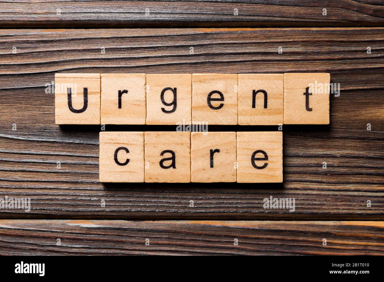 Urgent care word written on wood block. Urgent care text on wooden ...