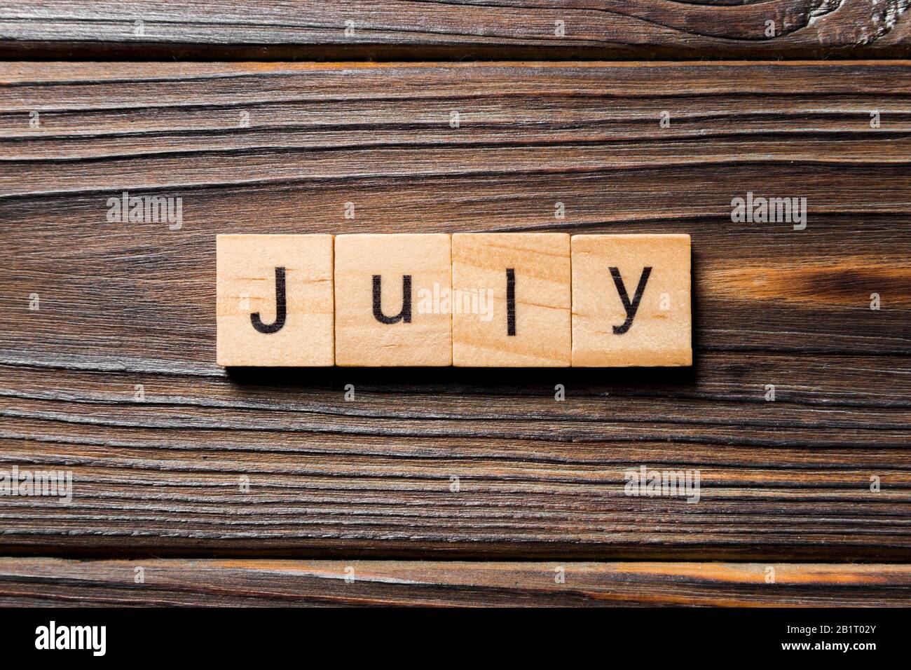 July word written on wood block. July text on wooden table for your ...