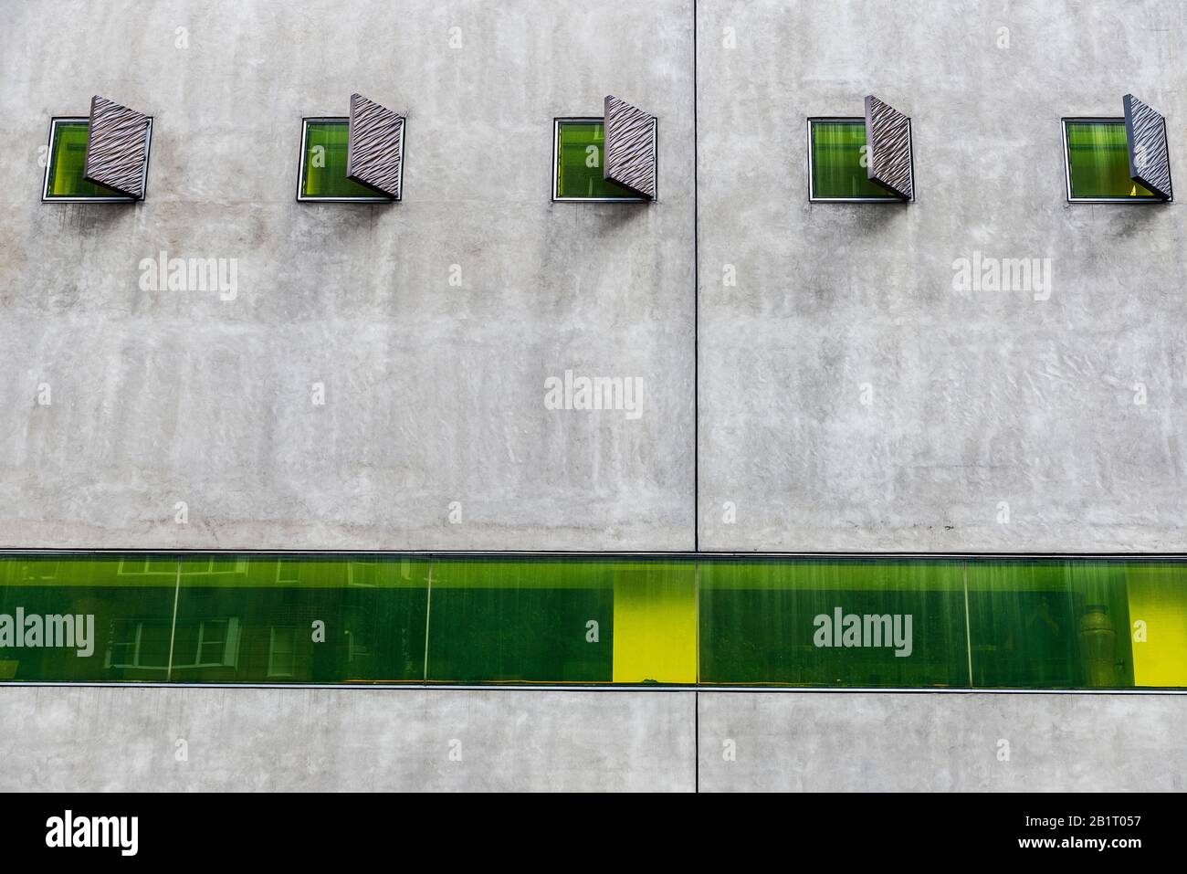 Five windows open on the concrete facade of a building as abstract ...