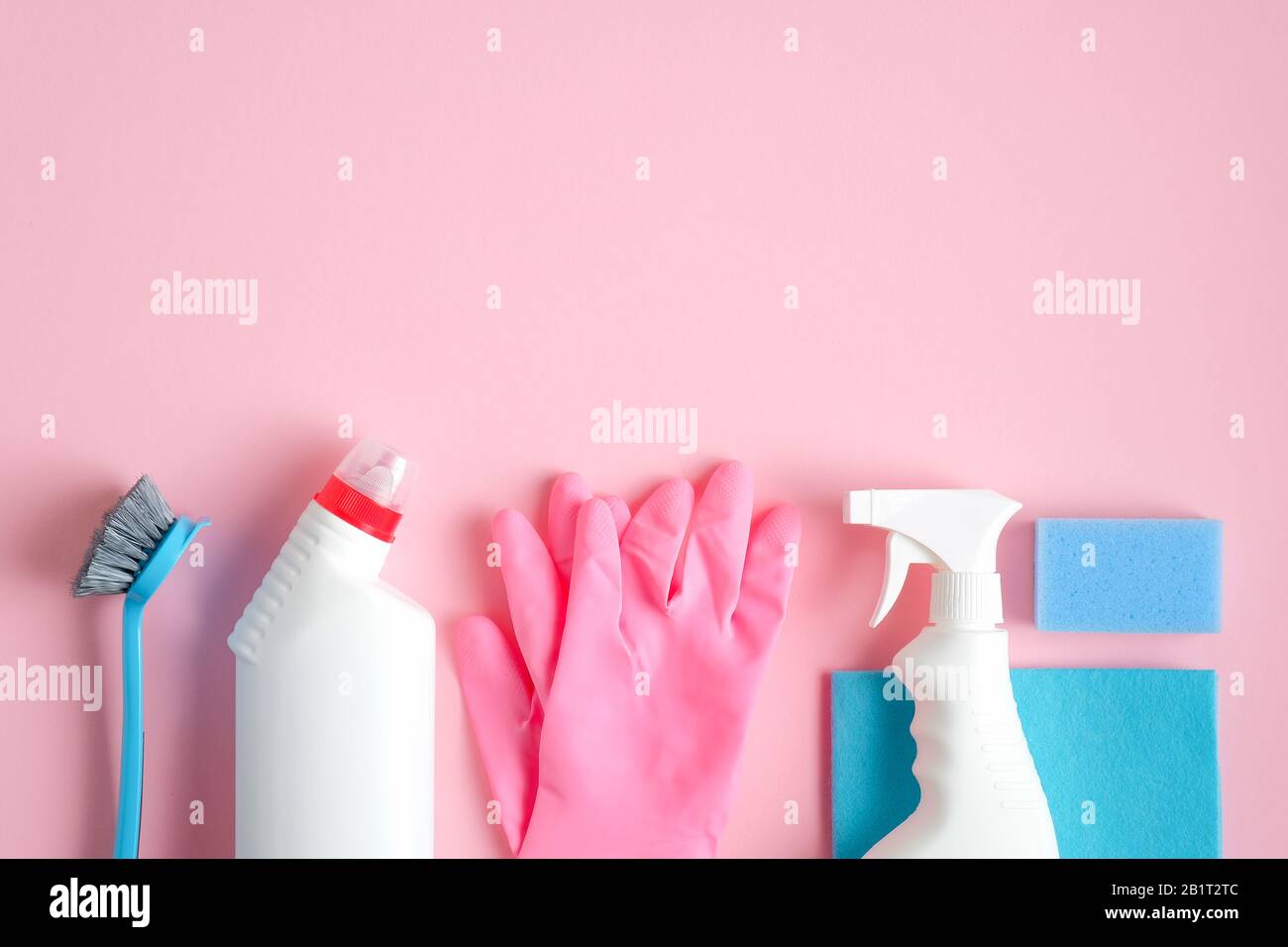 House cleaning tools and cleaning products on pink background. Top view ...