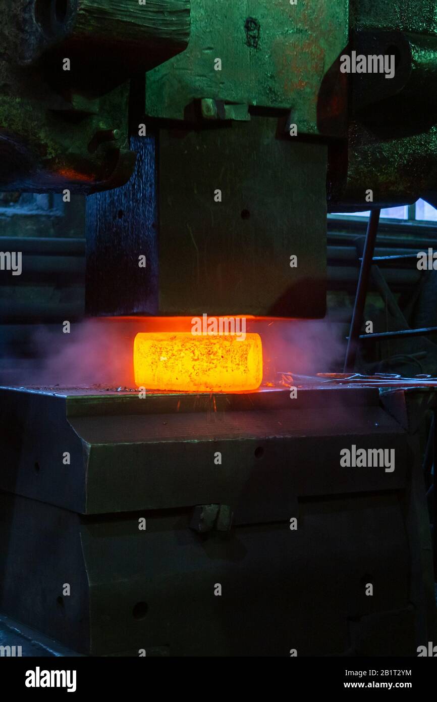 close-up picture of hot steel manual forging process with big ...