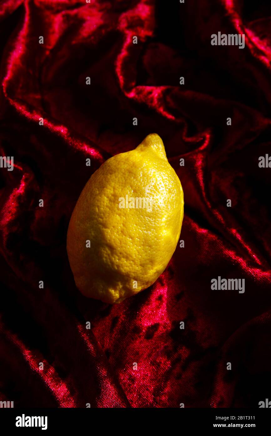 Lemon on red velvet background Stock Photo - Alamy