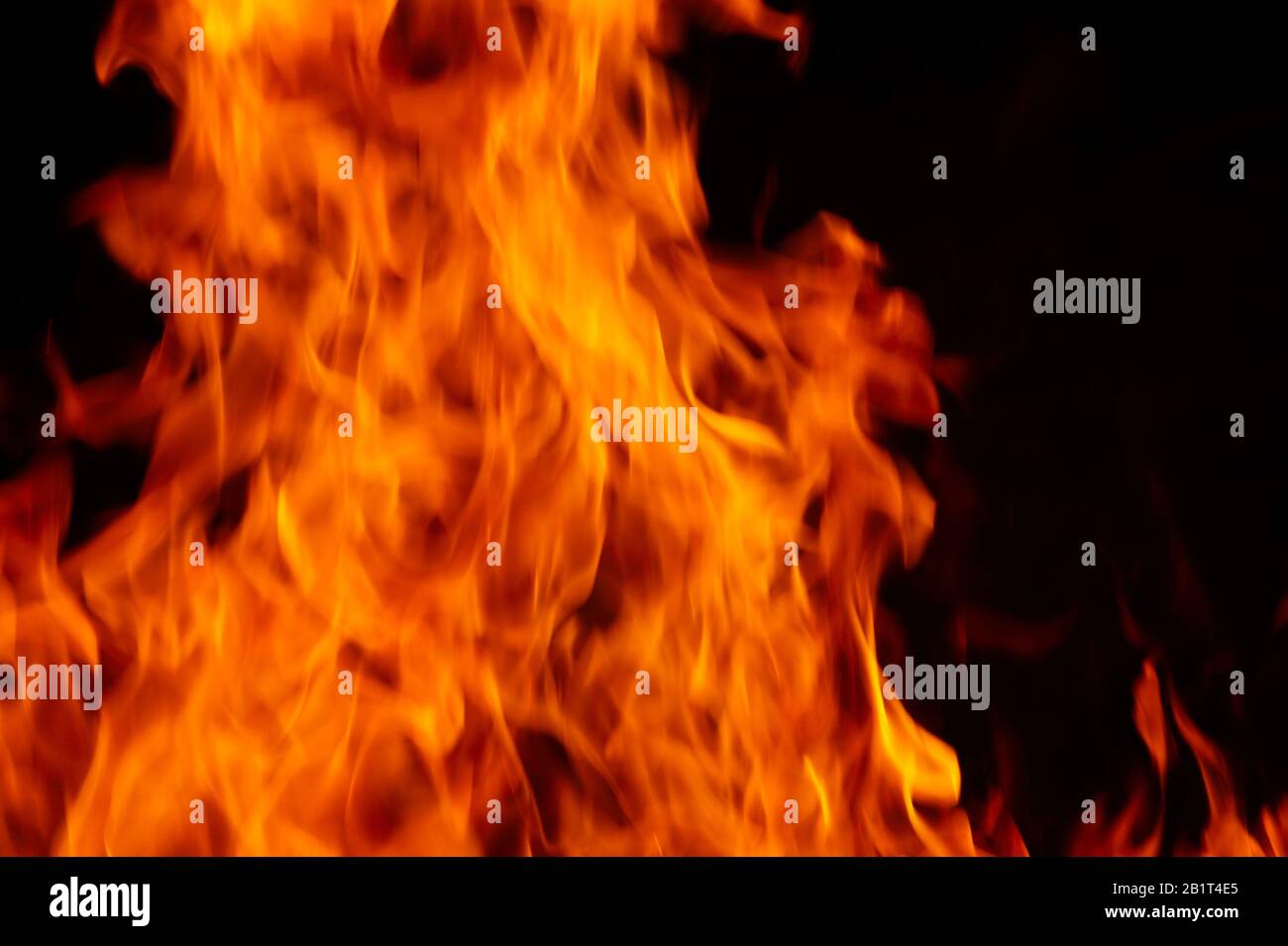 A background filled with defocused fire flames. High temperature and ...