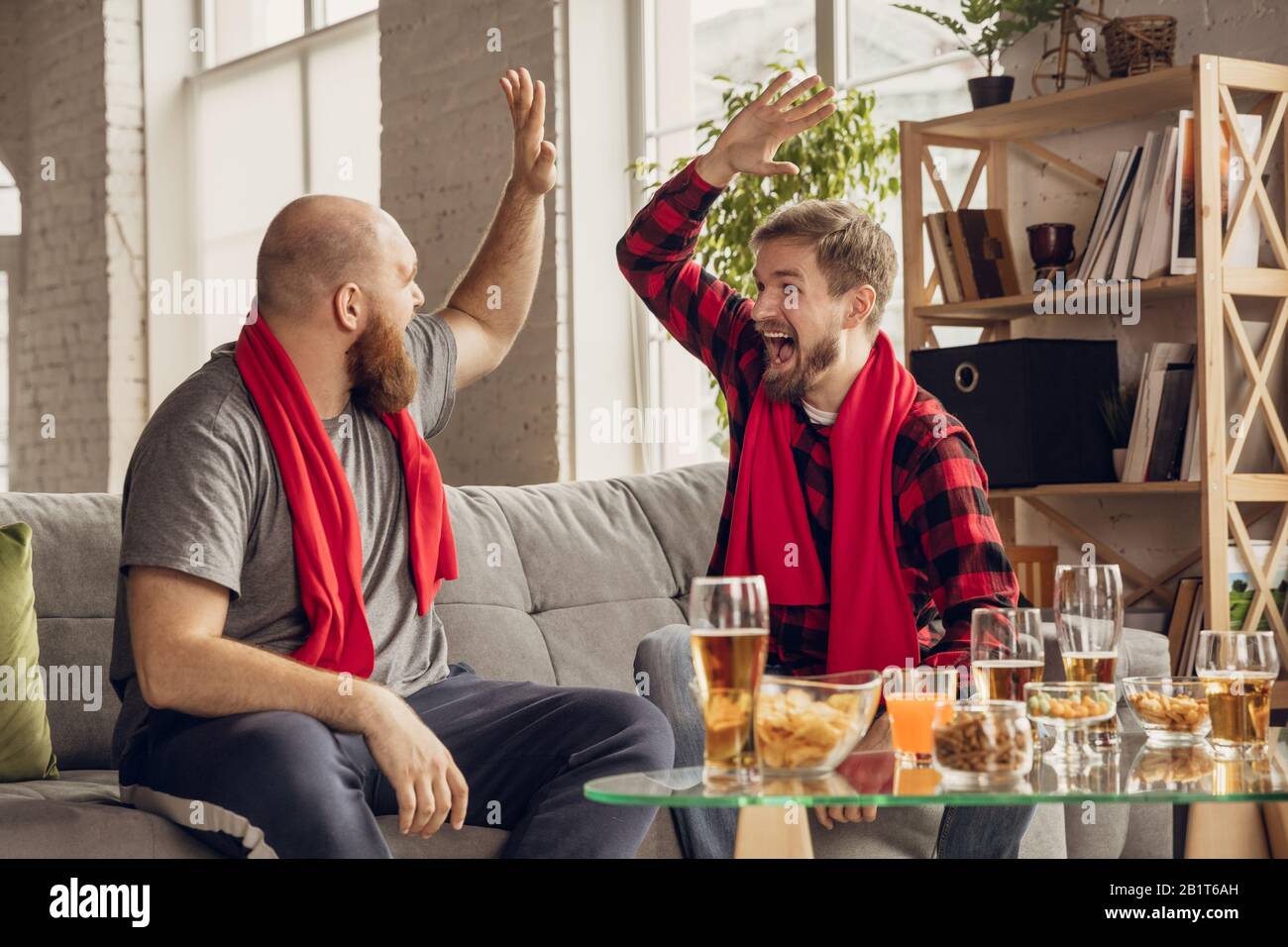 Victory. Excited, happy friends watching basketball, football, soccer ...
