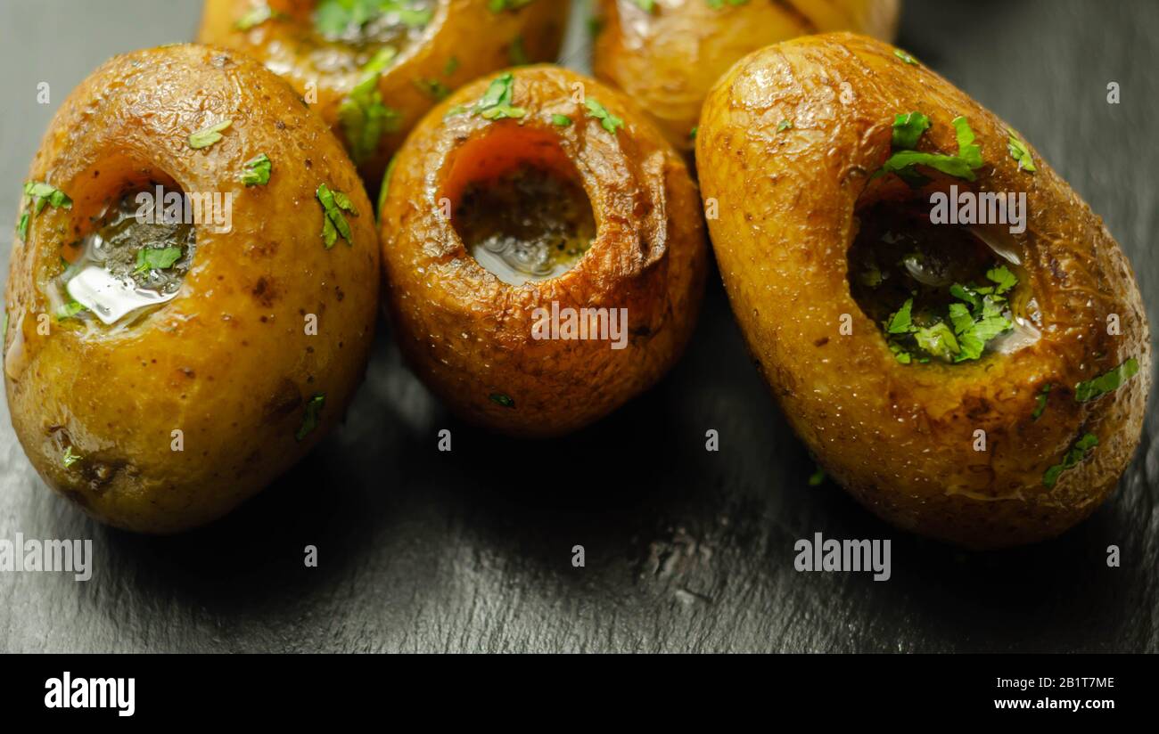 Mini jacket potatoes with a fragrant garlic butter infused with Italian ...