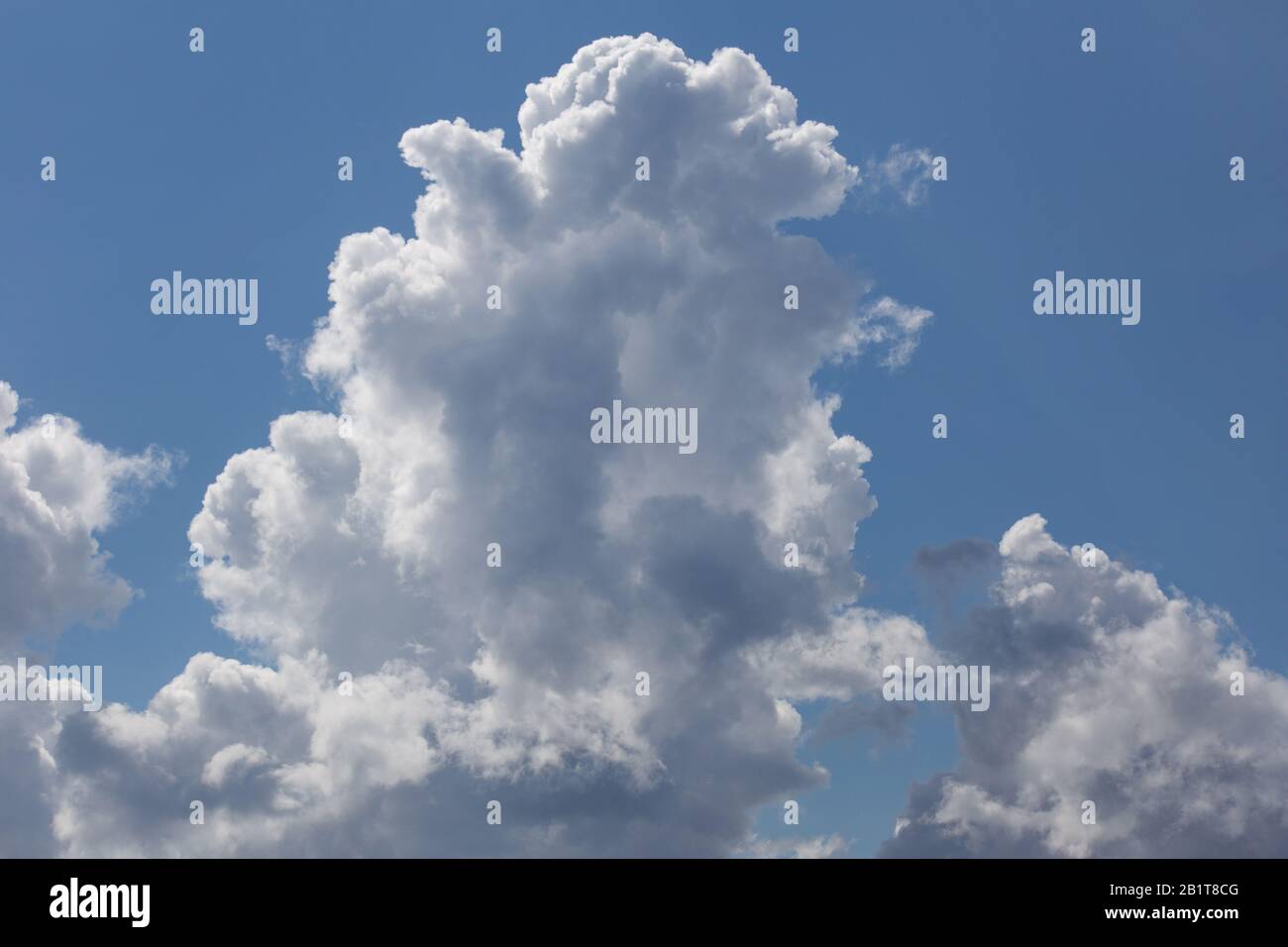 Big rain clouds in bright sunlights on a blue sky. Planet earth Stock ...