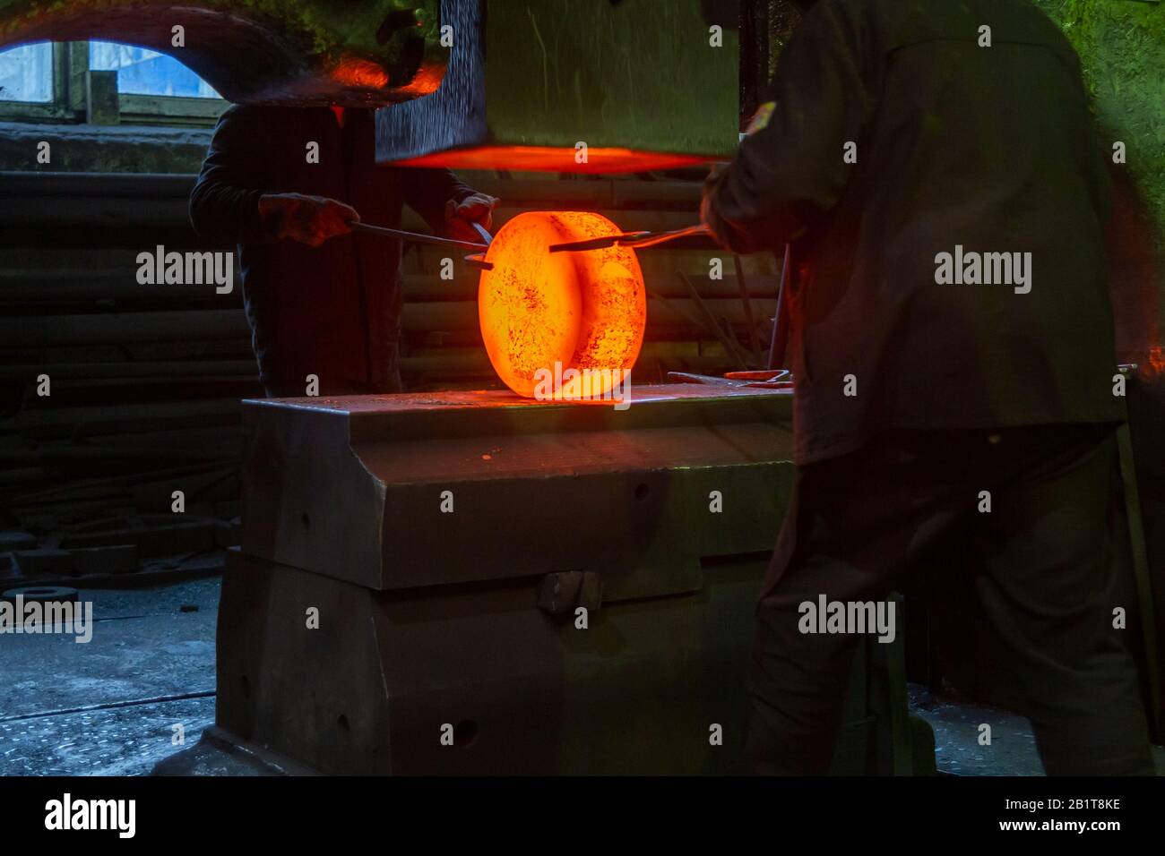 close-up picture of hot steel manual forging process with big ...