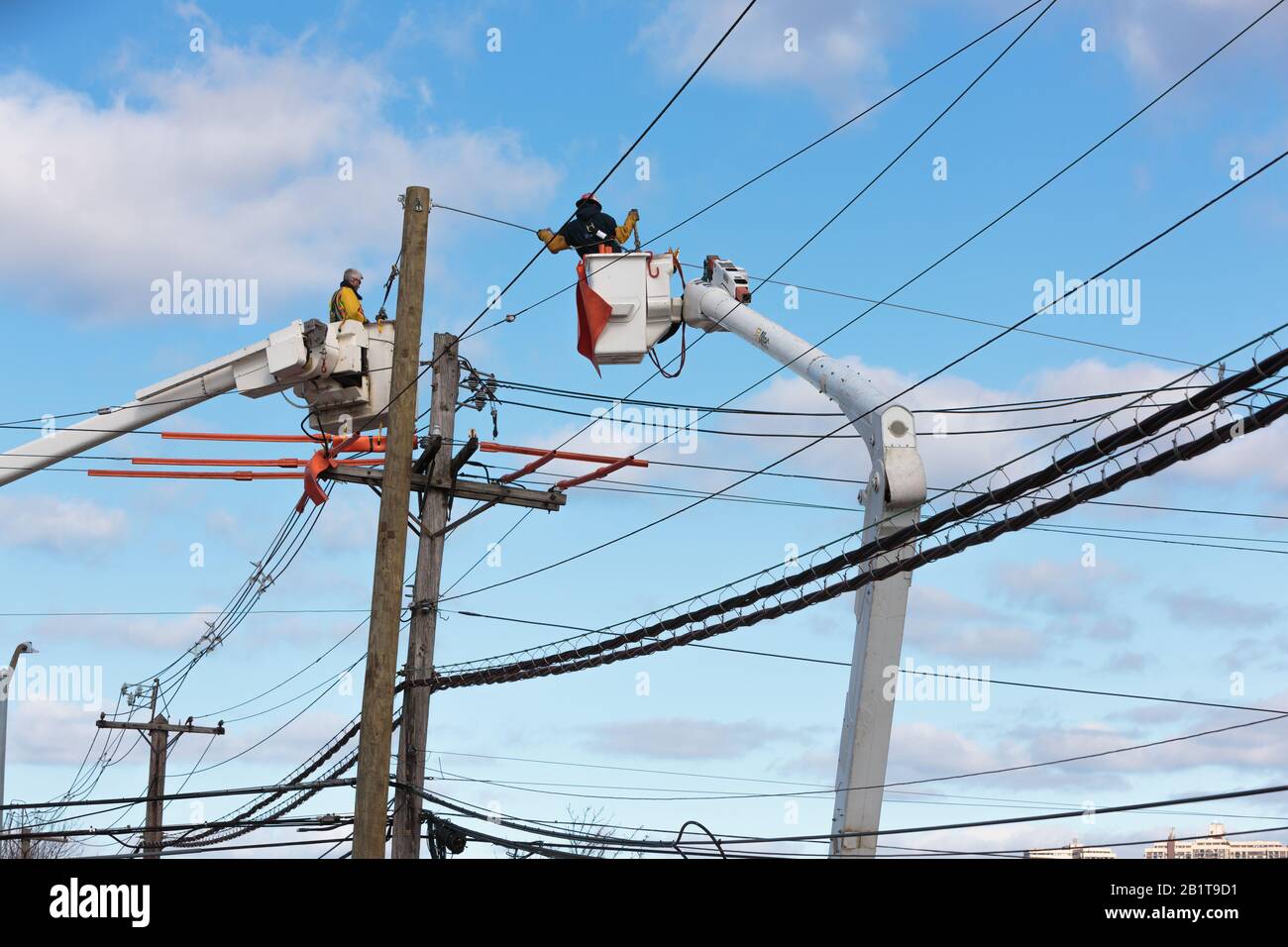 A sequence of images of a wooden electrical utility pole being replaced ...