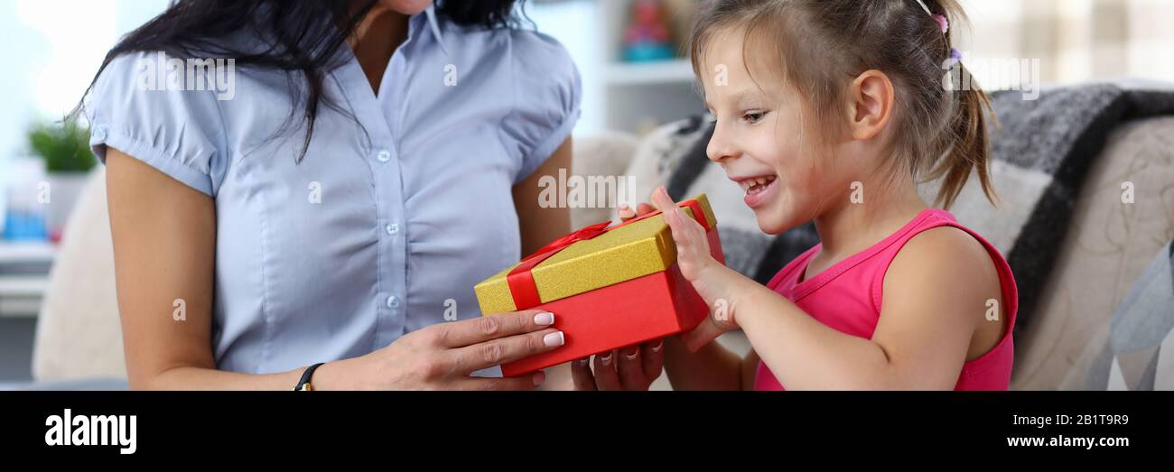 Mom Giving Gift To Girl Stock Photo Alamy