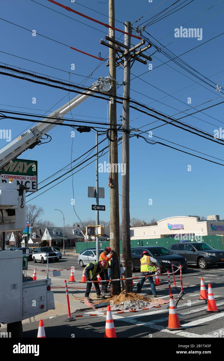 A sequence of images of a wooden electrical utility pole being replaced ...