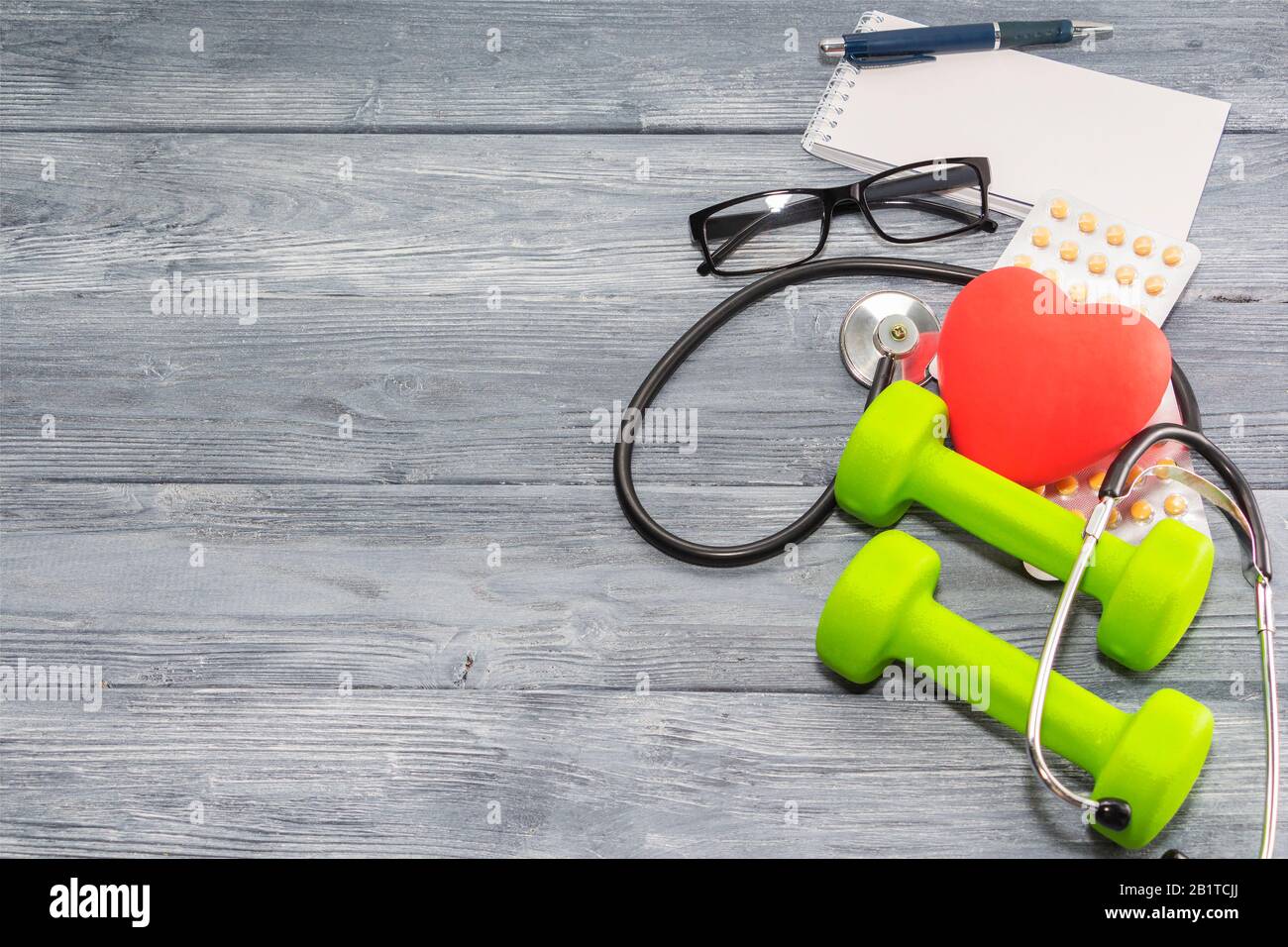 Red heart on the background of pills. Concept of health, heart disease ...