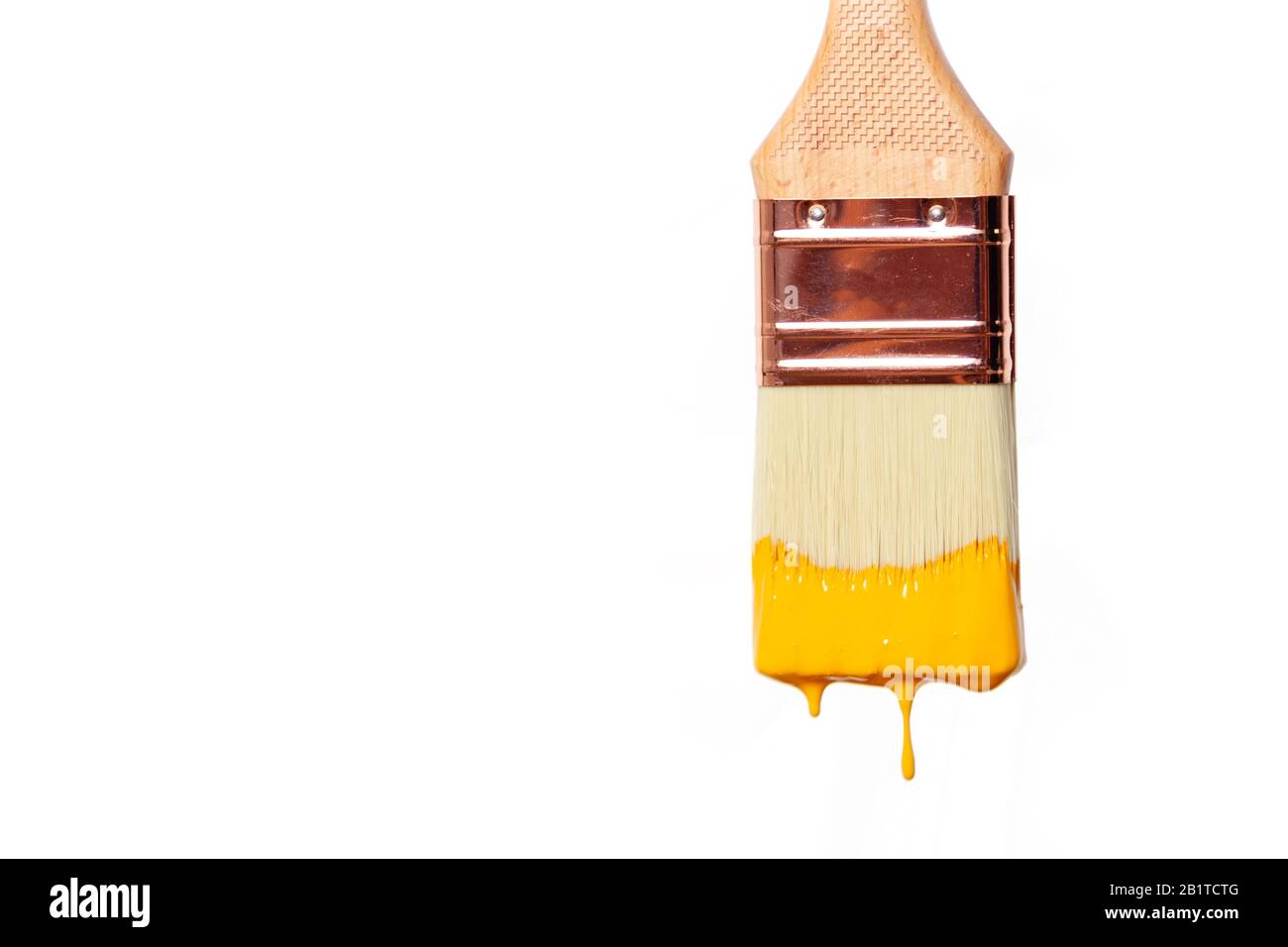 Paintbrush with dripping yellow paint isolated on white background ...