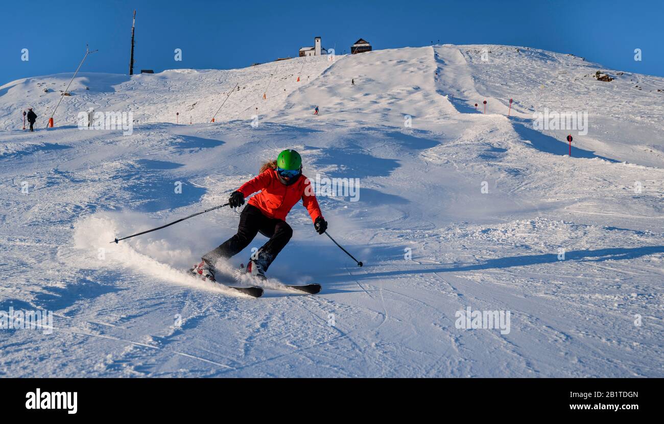 Skier descending a steep slope hi-res stock photography and images - Alamy