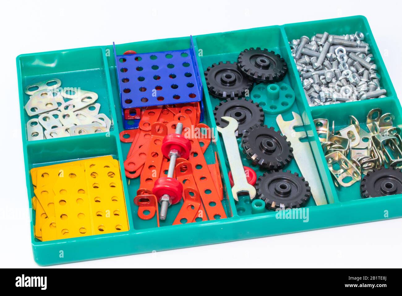 Green plastic box with different colors metal constructor details ...