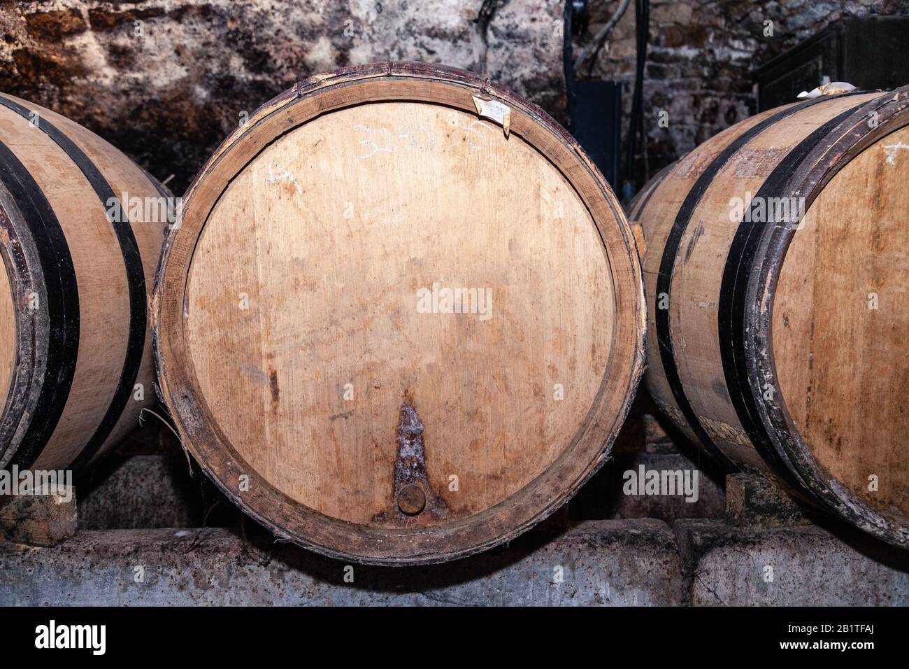 Wooden giant wine oak barrels stacked in rows. Aging, fermentation ...