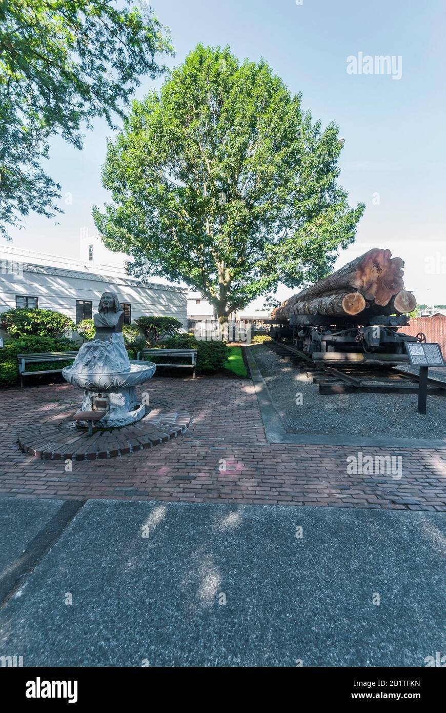 Sculpted Bust of Chief Seattle fountain and a rail car with wooden logs ...