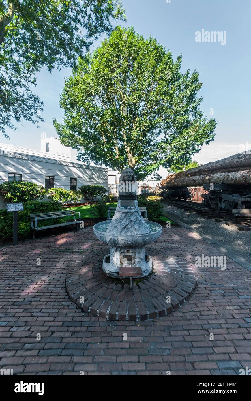 Sculpted Bust of Chief Seattle fountain and a rail car with wooden logs ...
