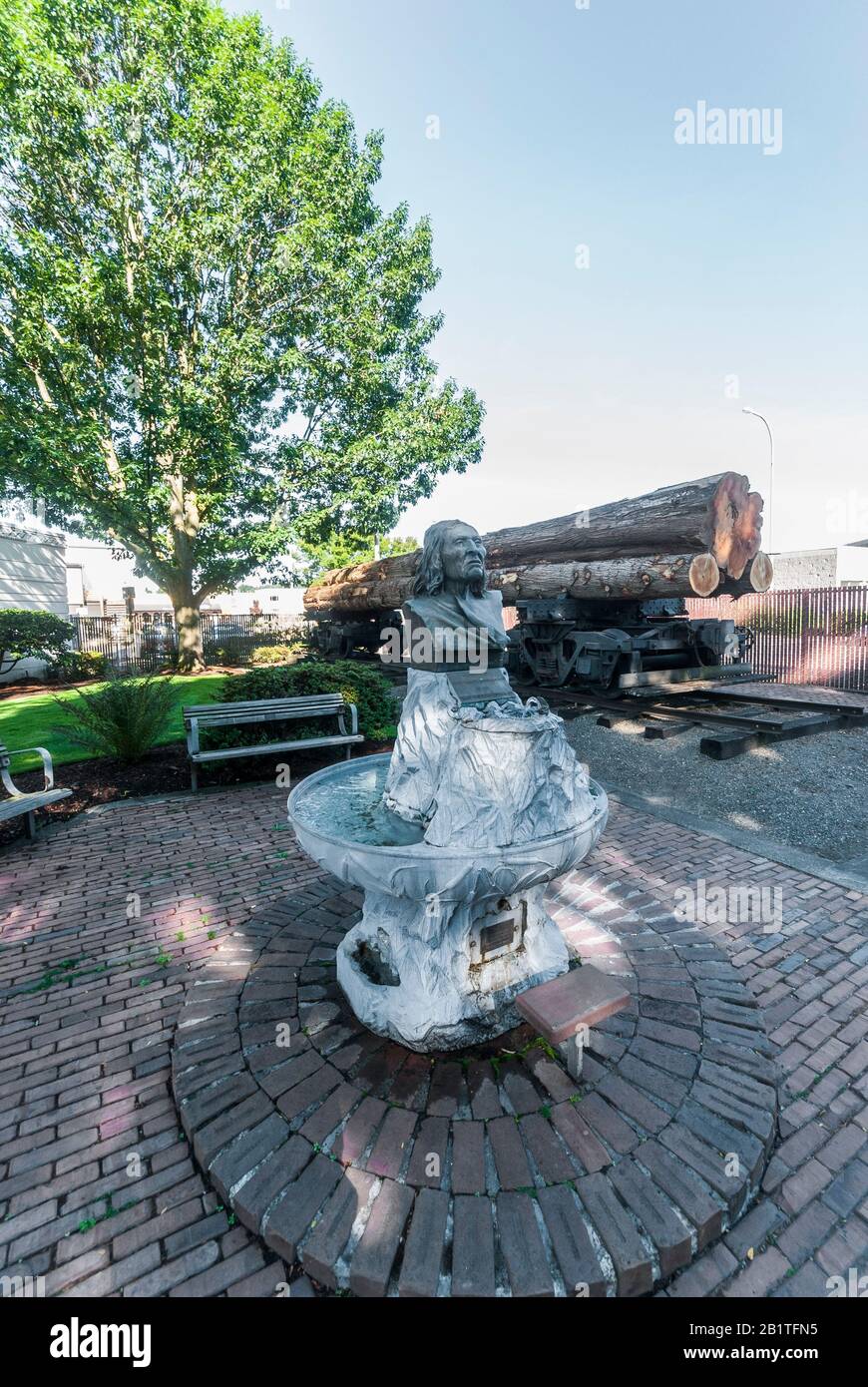 Sculpted Bust of Chief Seattle fountain and a rail car with wooden logs ...
