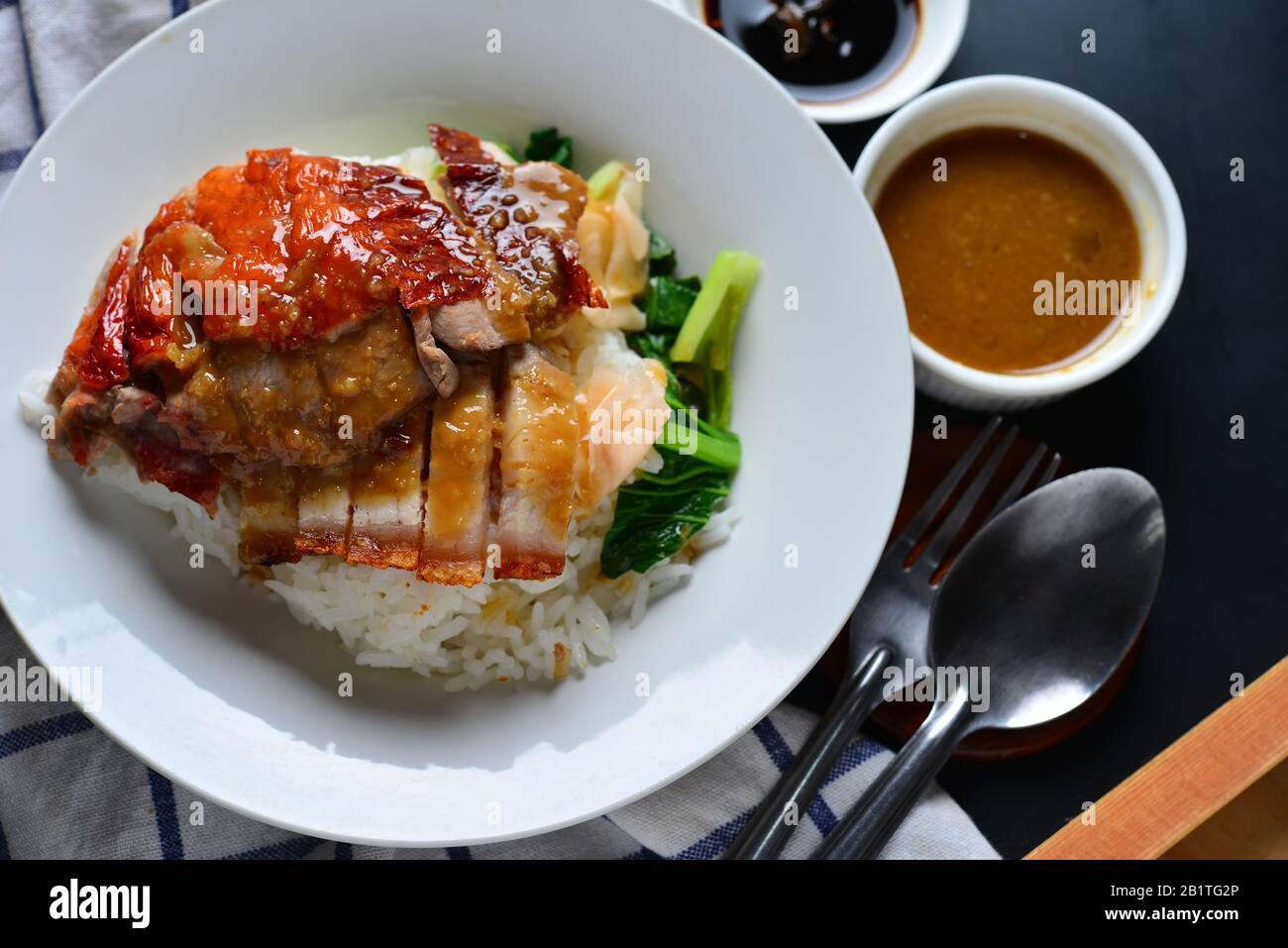 Rice with roasted duck and crispy skin pork belly Stock Photo - Alamy