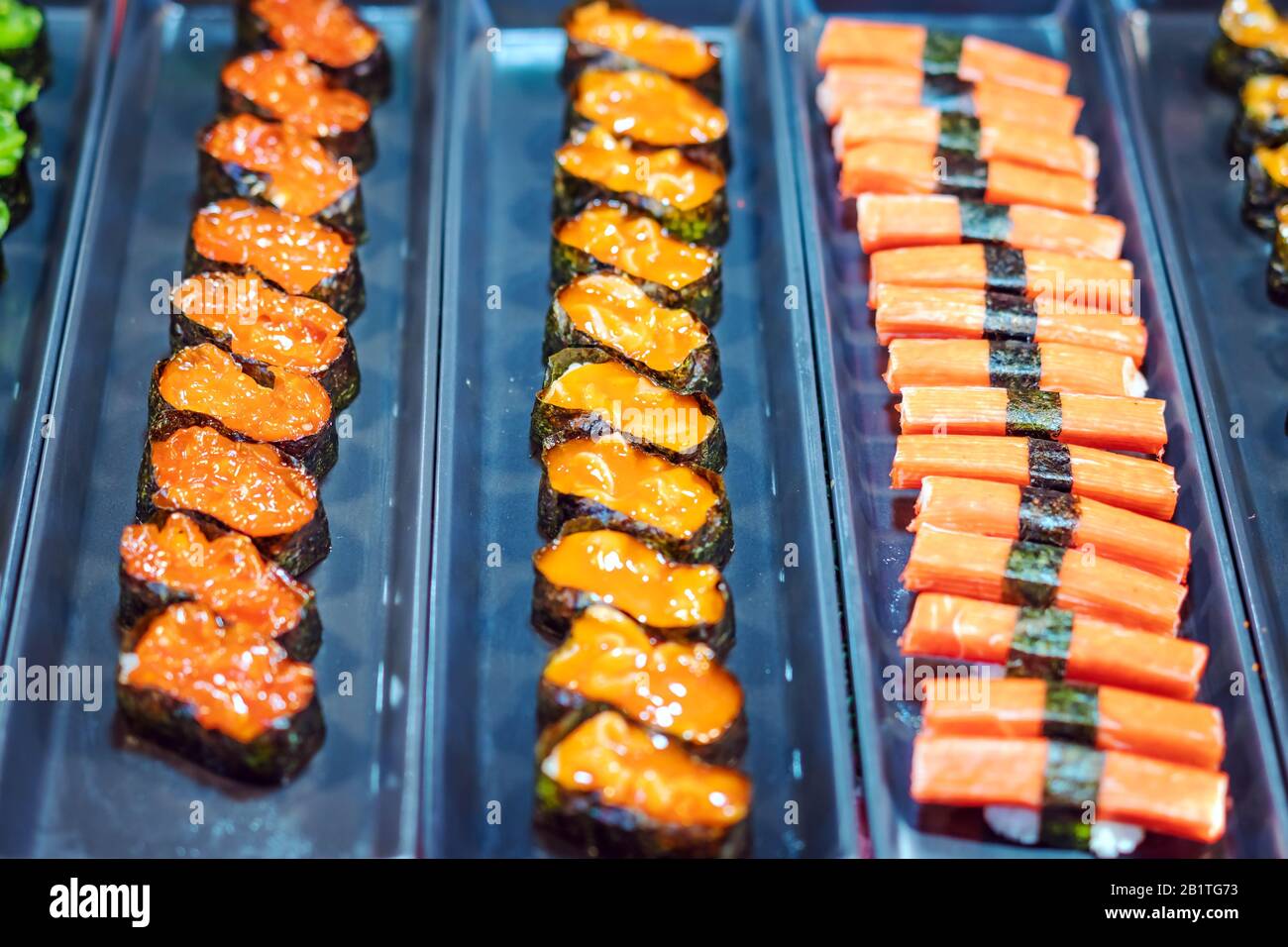 Rows of japanese sushi food. Maki ands rolls with tuna, salmon, shrimp ...
