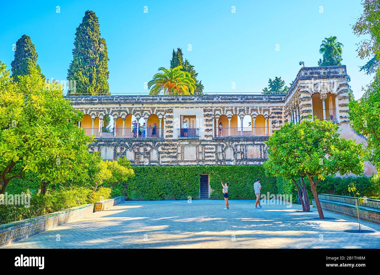 SEVILLE, SPAIN - OCTOBER 1, 2019: The tourists walk in arched Grotesque ...