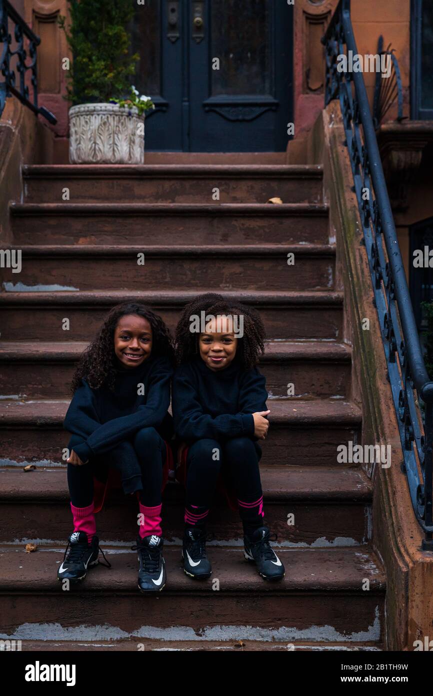 Two sisters sitting on stairs hi-res stock photography and images - Alamy