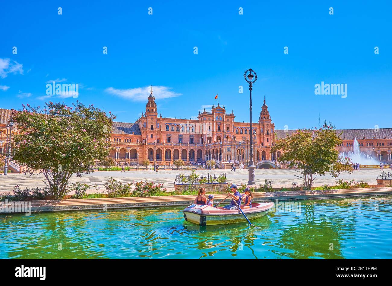 SEVILLE, SPAIN - OCTOBER 1, 2019: The family sails along the canal in ...