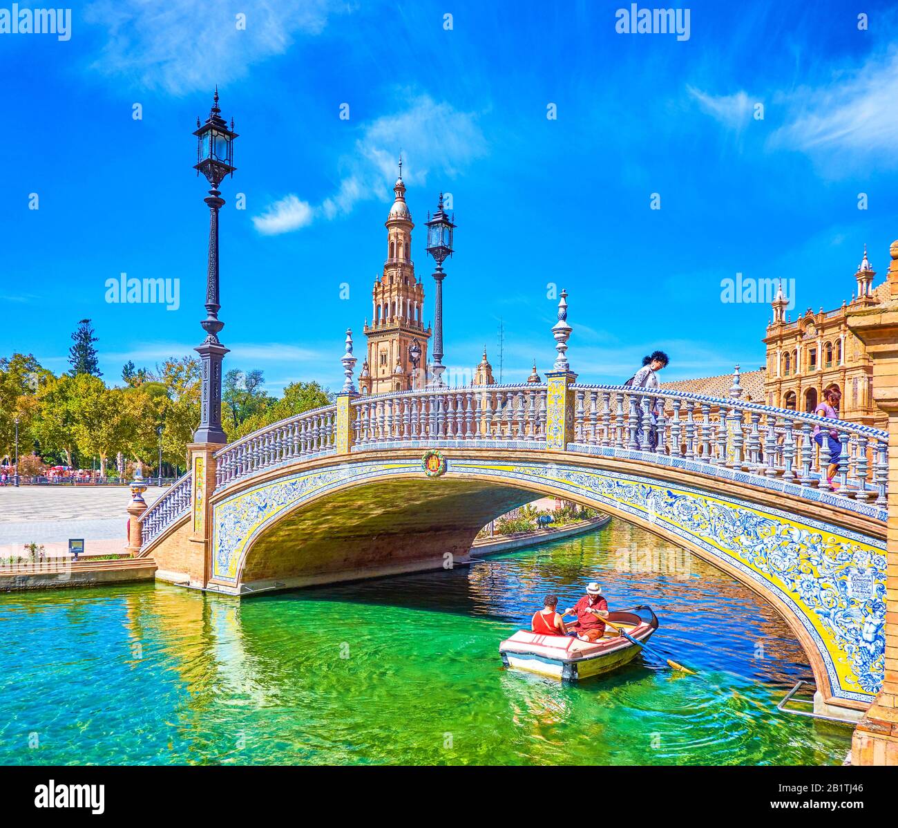 SEVILLE, SPAIN - OCTOBER 1, 2019: The tourists sail on the small vessel ...