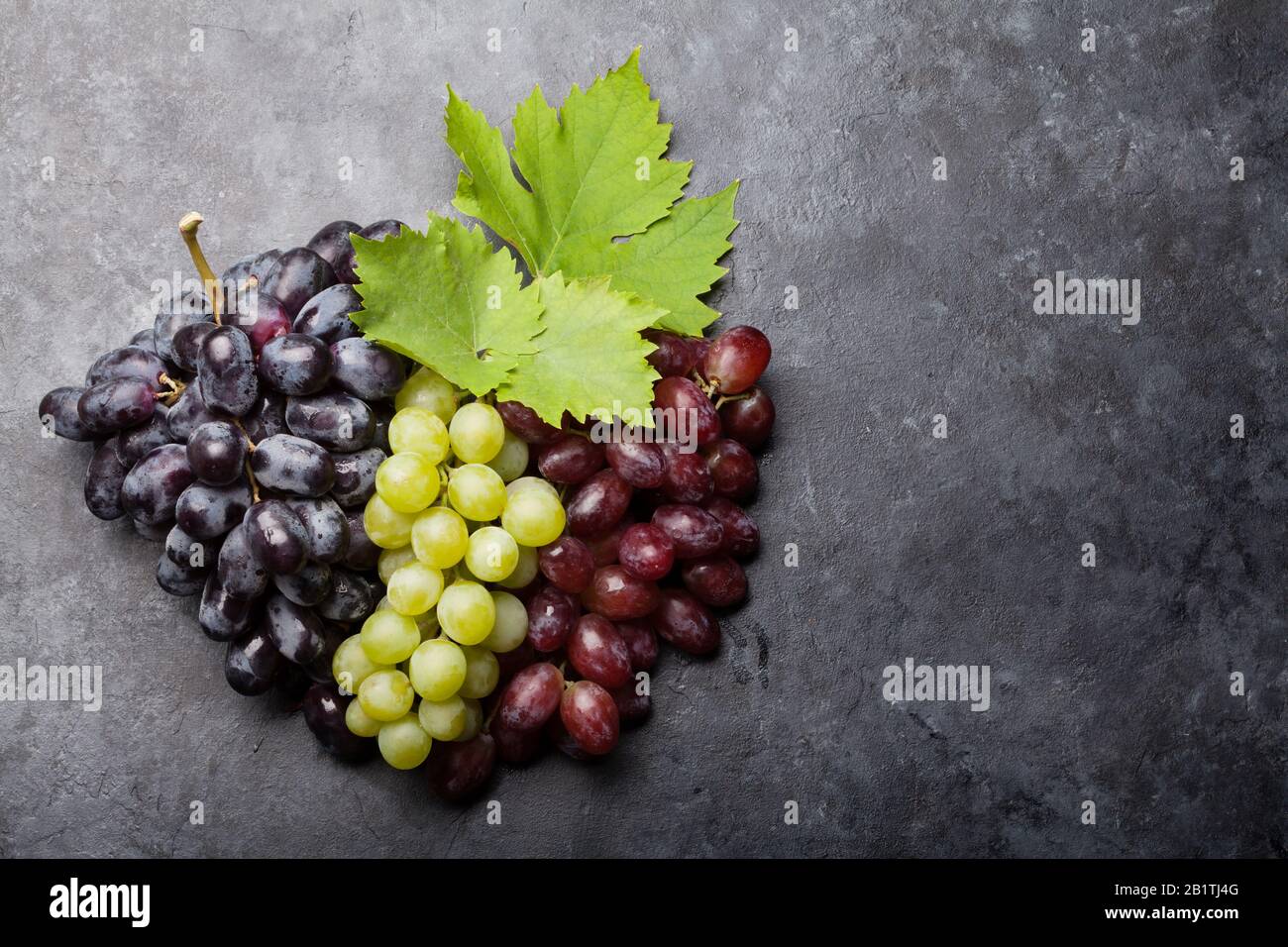 Colorful grapes on stone table. Top view flat lay Stock Photo - Alamy
