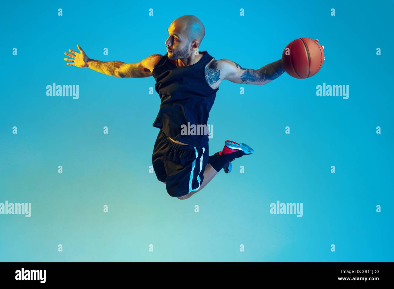 In jump. Young basketball player of team wearing sportwear training ...