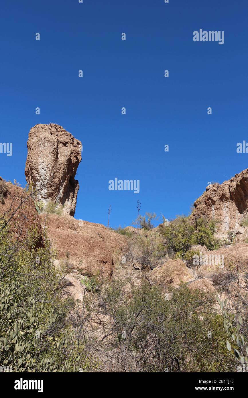 A rock formation on the peak of a mountain in the Sonoran desert with ...