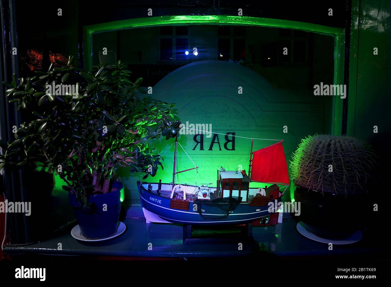 ‎Scale model boat with green lighting on window ledge indoors Stock ...
