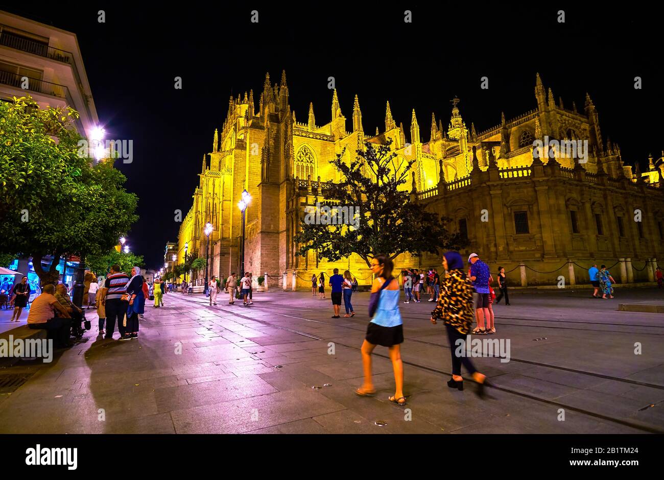 SEVILLE, SPAIN - OCTOBER 1, 2019: Tourists walk in old town on ...