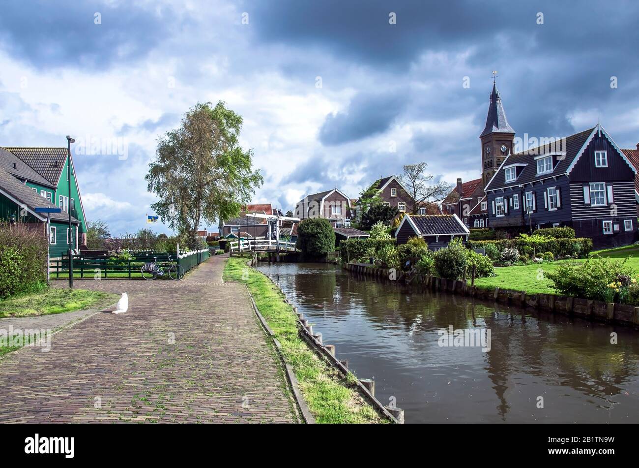 Traditional wooden fishing houses, canal and cat, Marken, Netherlands ...