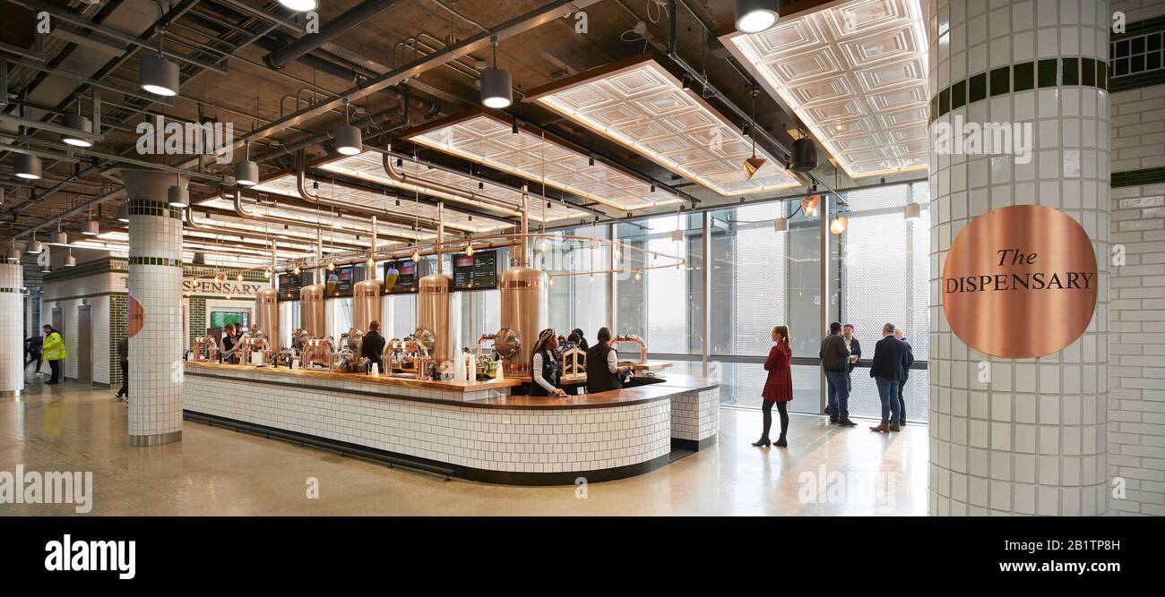 Pub-style feature bar for fans in concourse with window wall to stadium ...