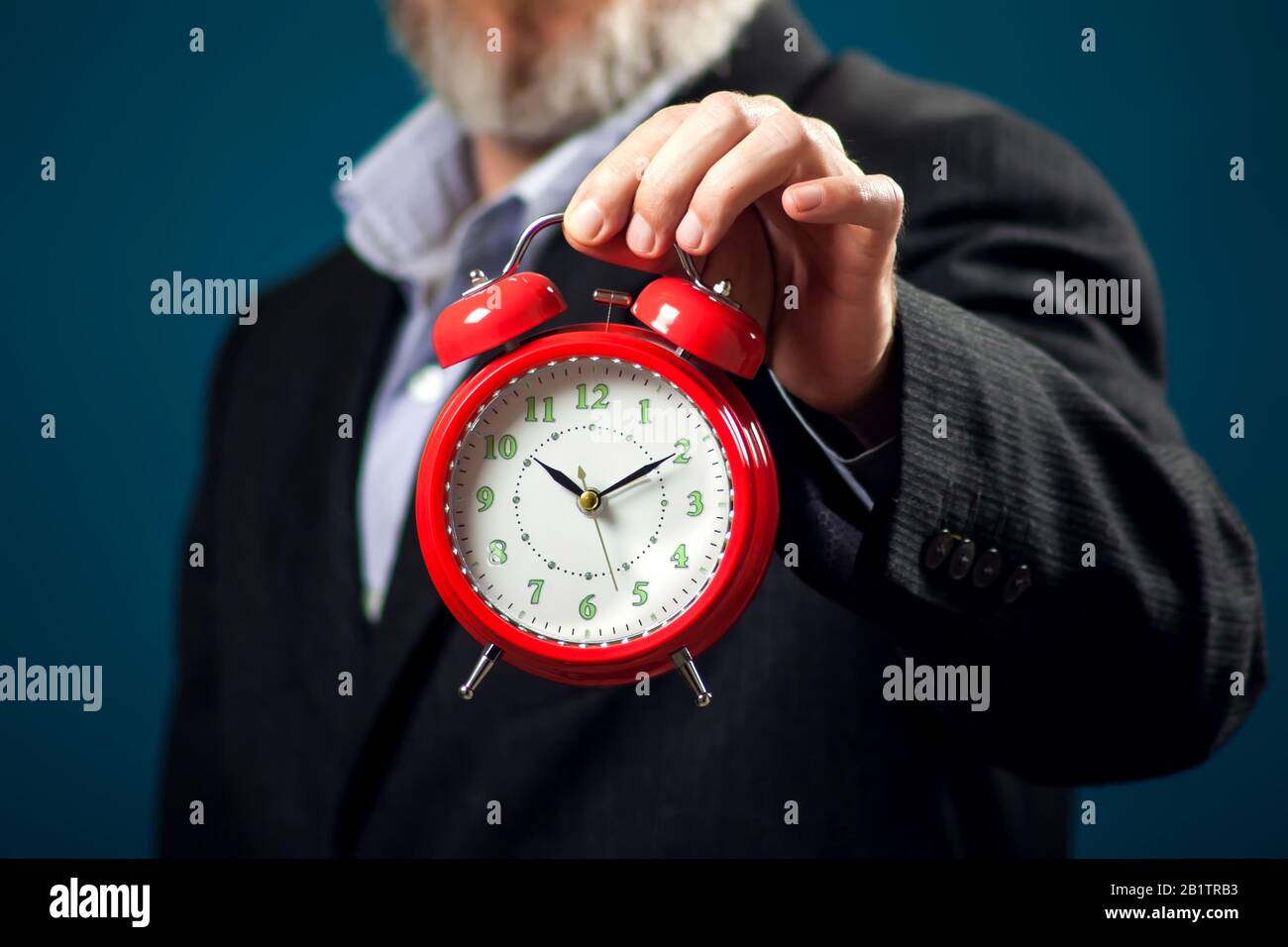 Bearded Businessman In Suit Holding Red Alarm Clock Time Management