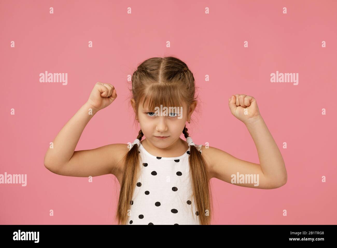 angry little child girl in dress raising fist frustrated and furious ...